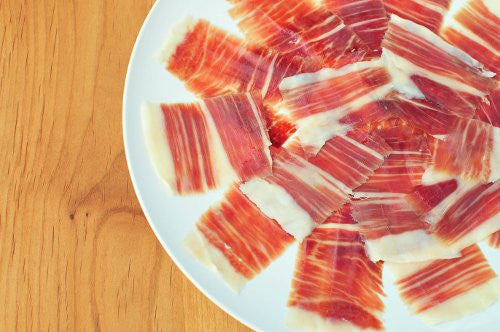 Hand carved sliced Jamón 100% Ibérico de Bellota "Pata Negra ...